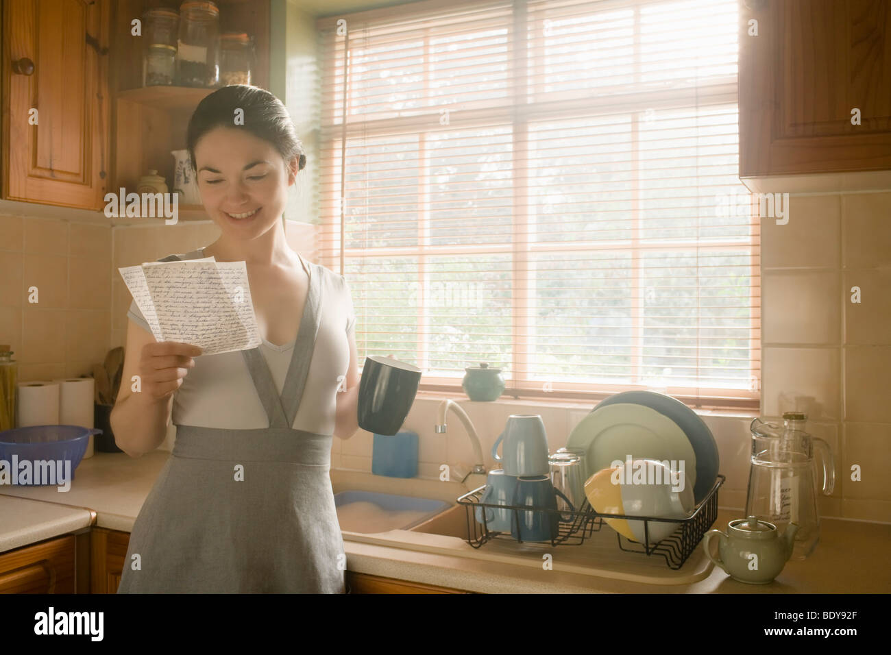 Woman reading letter Stock Photo - Alamy