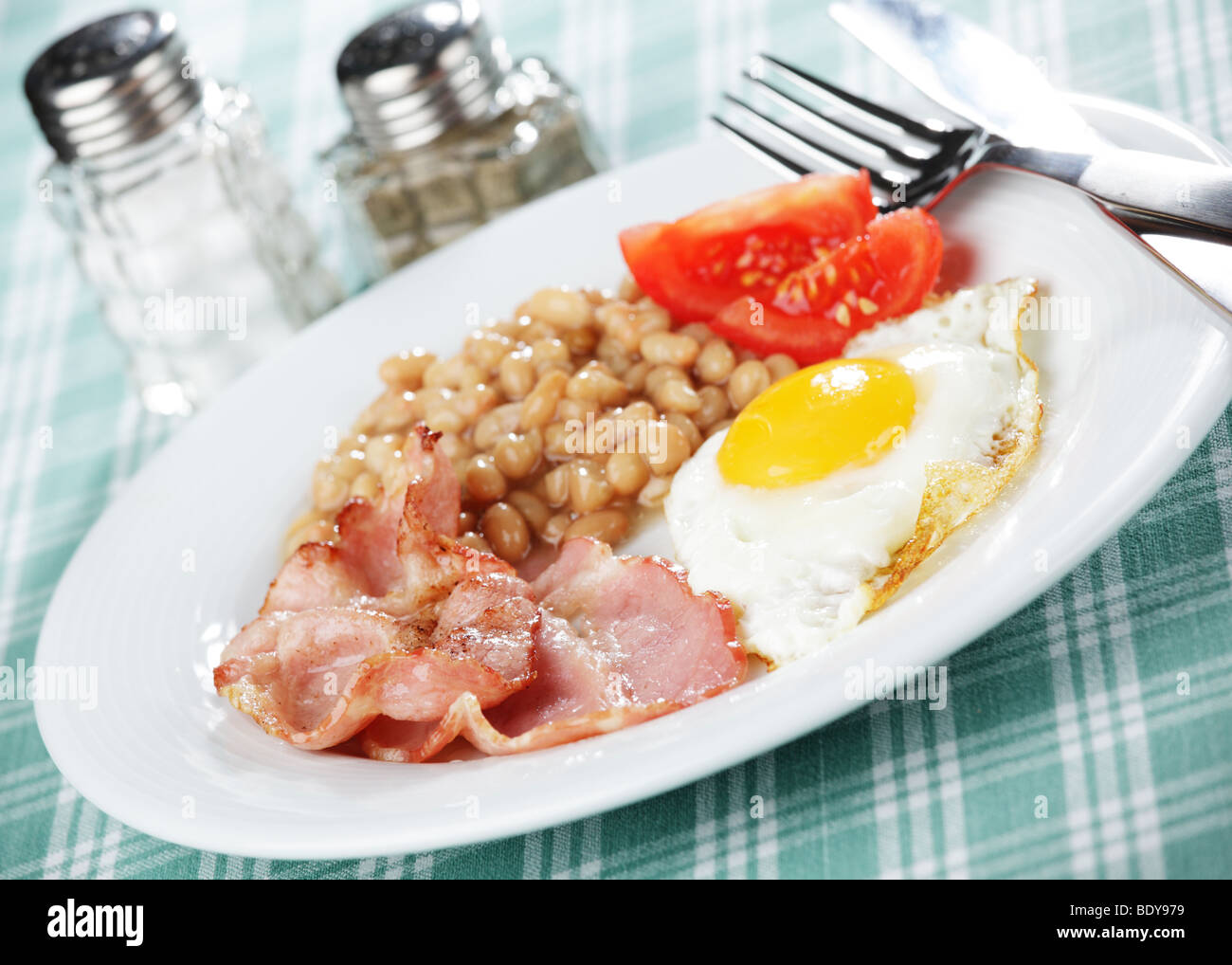 English breakfast with fried egg, ham, tomato, and string bean Stock ...