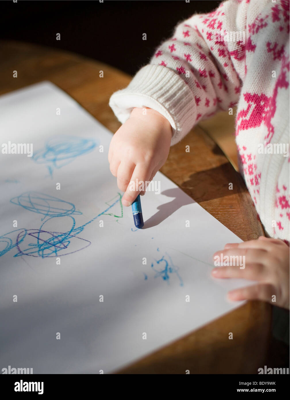 Toddler / young girl drawing with crayons Stock Photo - Alamy