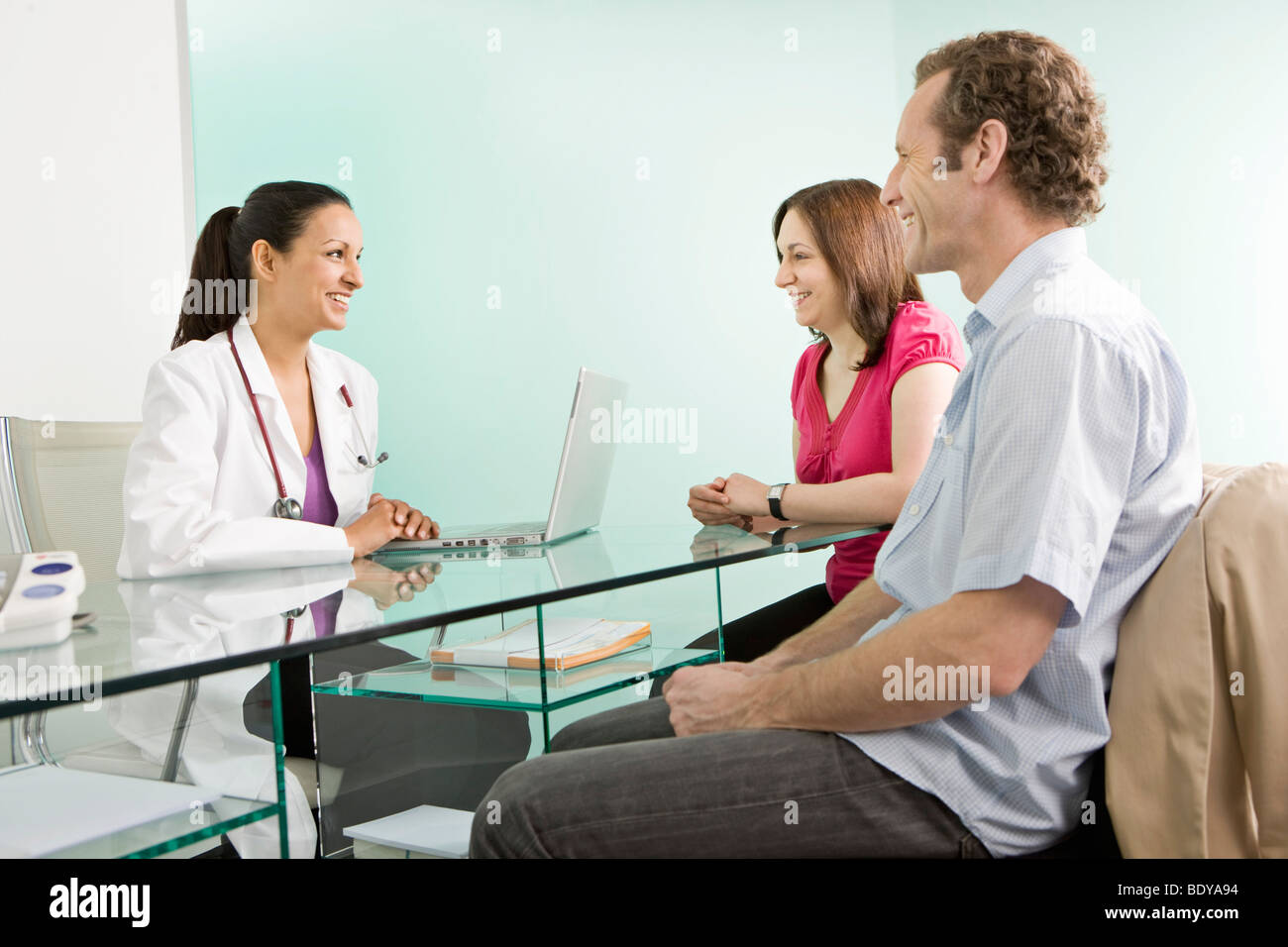 A female doctor with a couple Stock Photo - Alamy