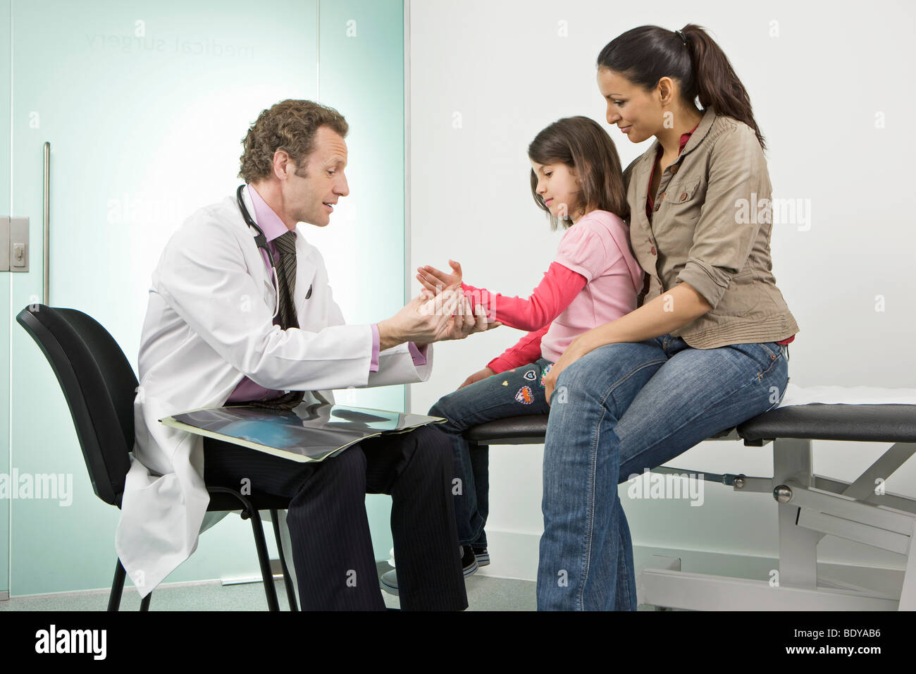 Male doctor checks a patients hand Stock Photo - Alamy