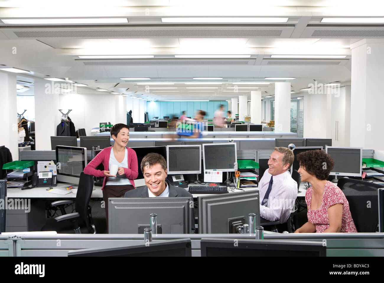 Four colleagues chatting at work Stock Photo - Alamy