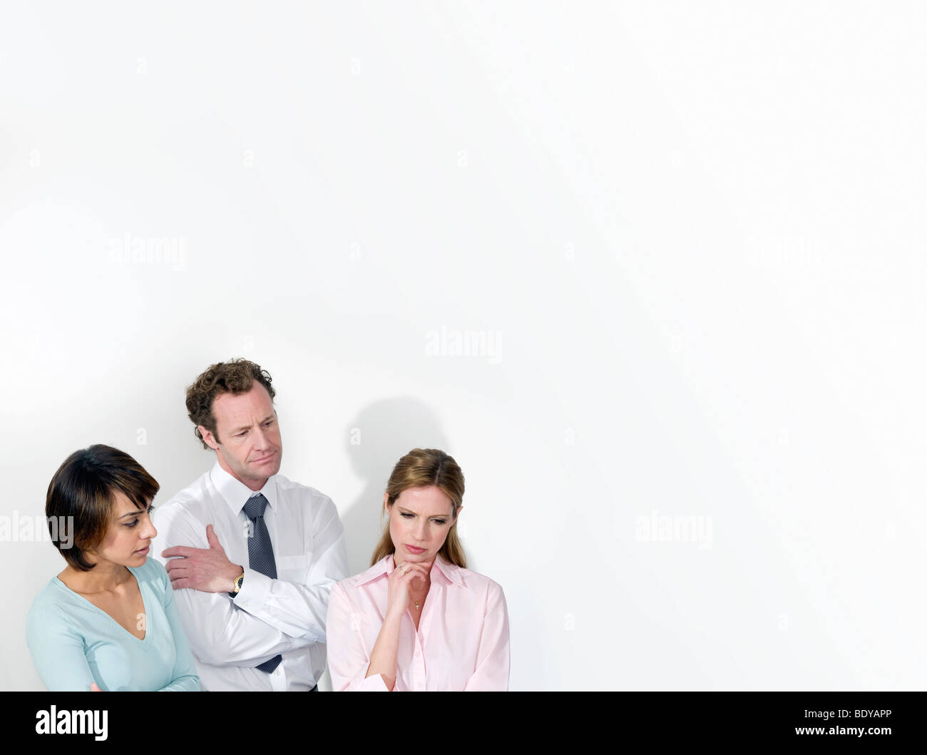 A business trio deliberating Stock Photo - Alamy