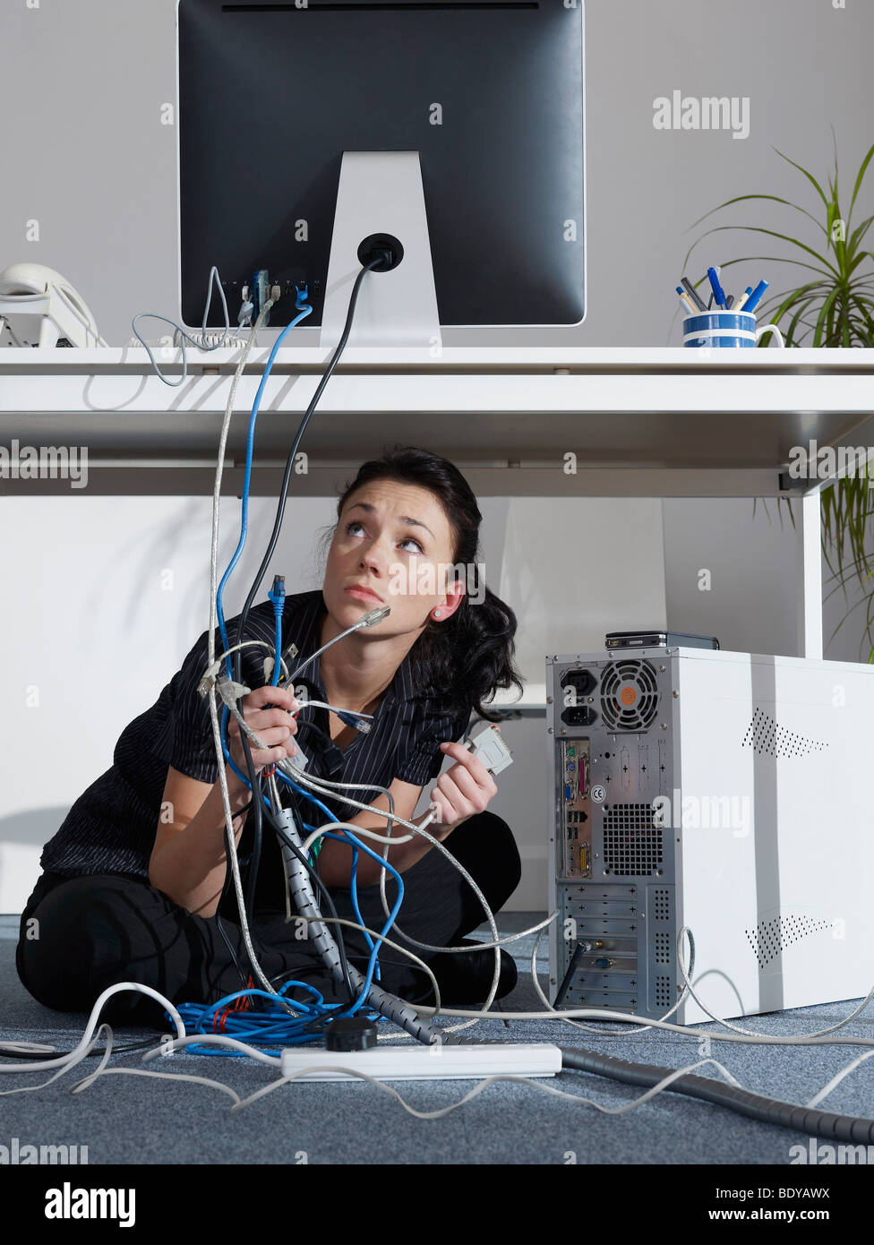 An office girl tries to fix her computer Stock Photo - Alamy