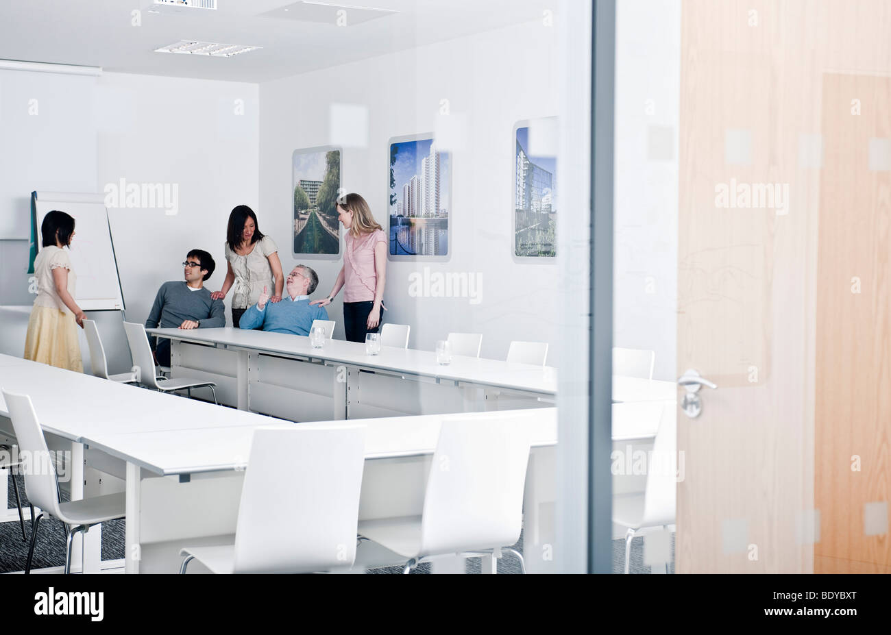 relaxed work group in meeting room Stock Photo - Alamy