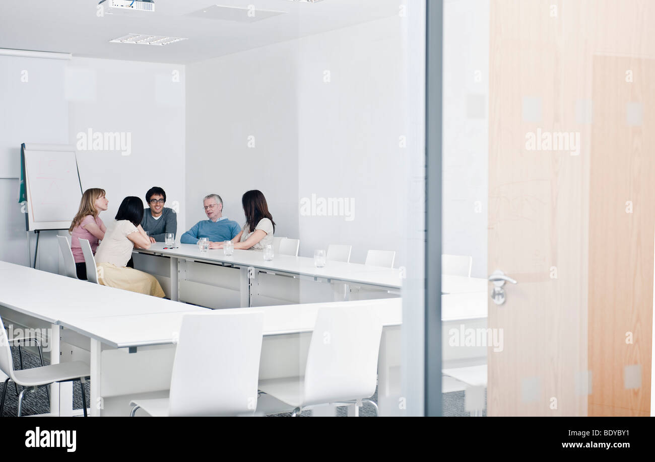 relaxed work group in meeting room Stock Photo - Alamy