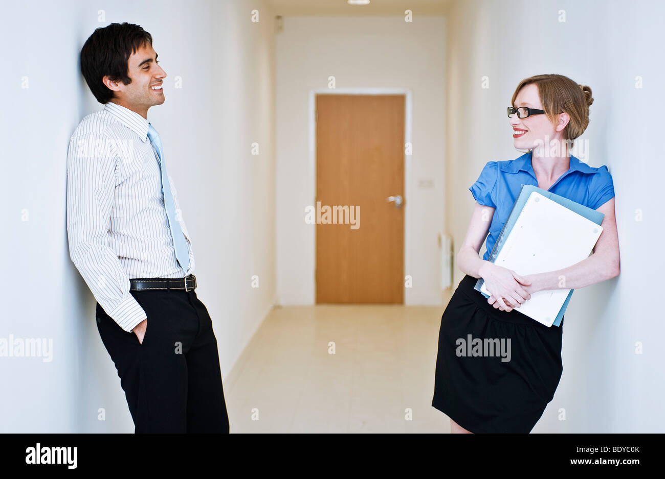 couple chatting in corridor Stock Photo - Alamy