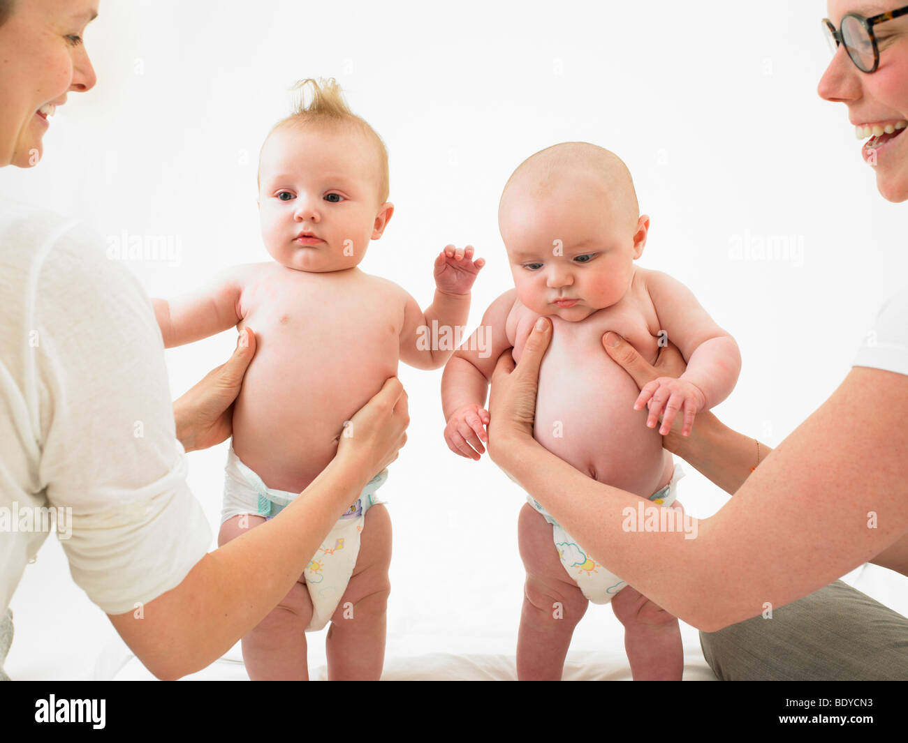 babies standing with help Stock Photo - Alamy