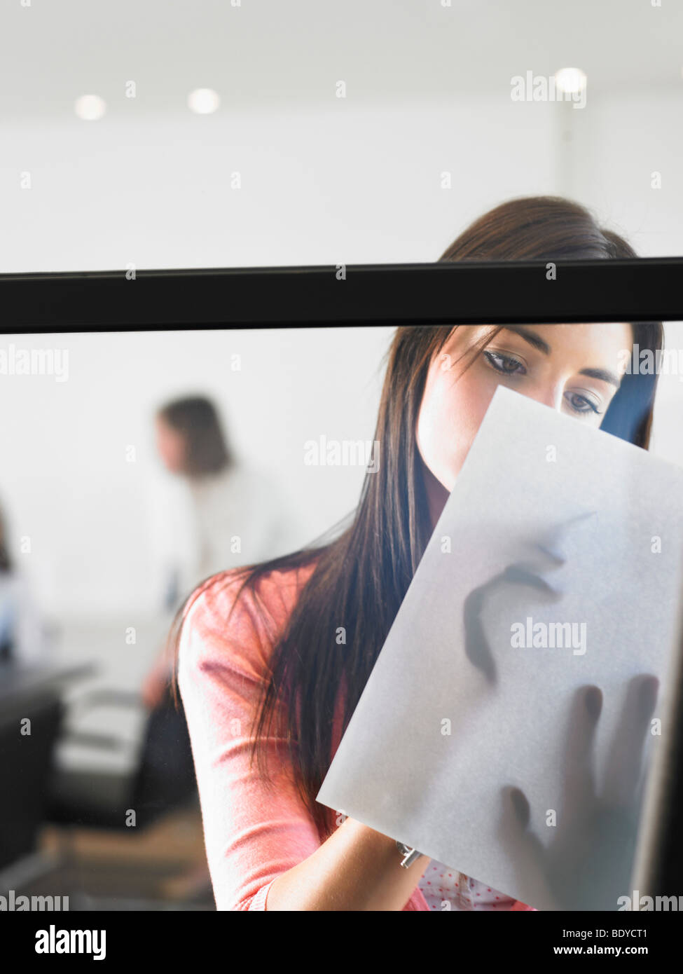 woman writing against window Stock Photo - Alamy