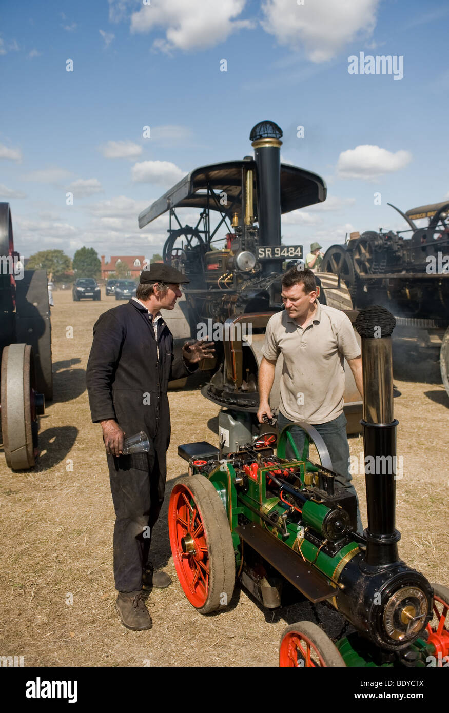 Two male enthusiasts with a scale model traction engine at a country ...