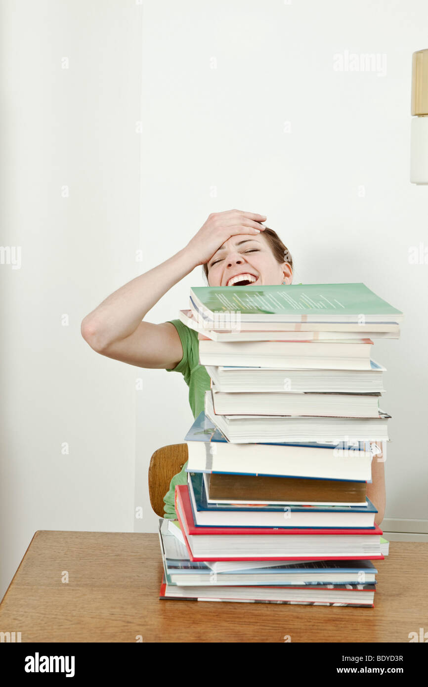 Female student with stack of books Stock Photo - Alamy