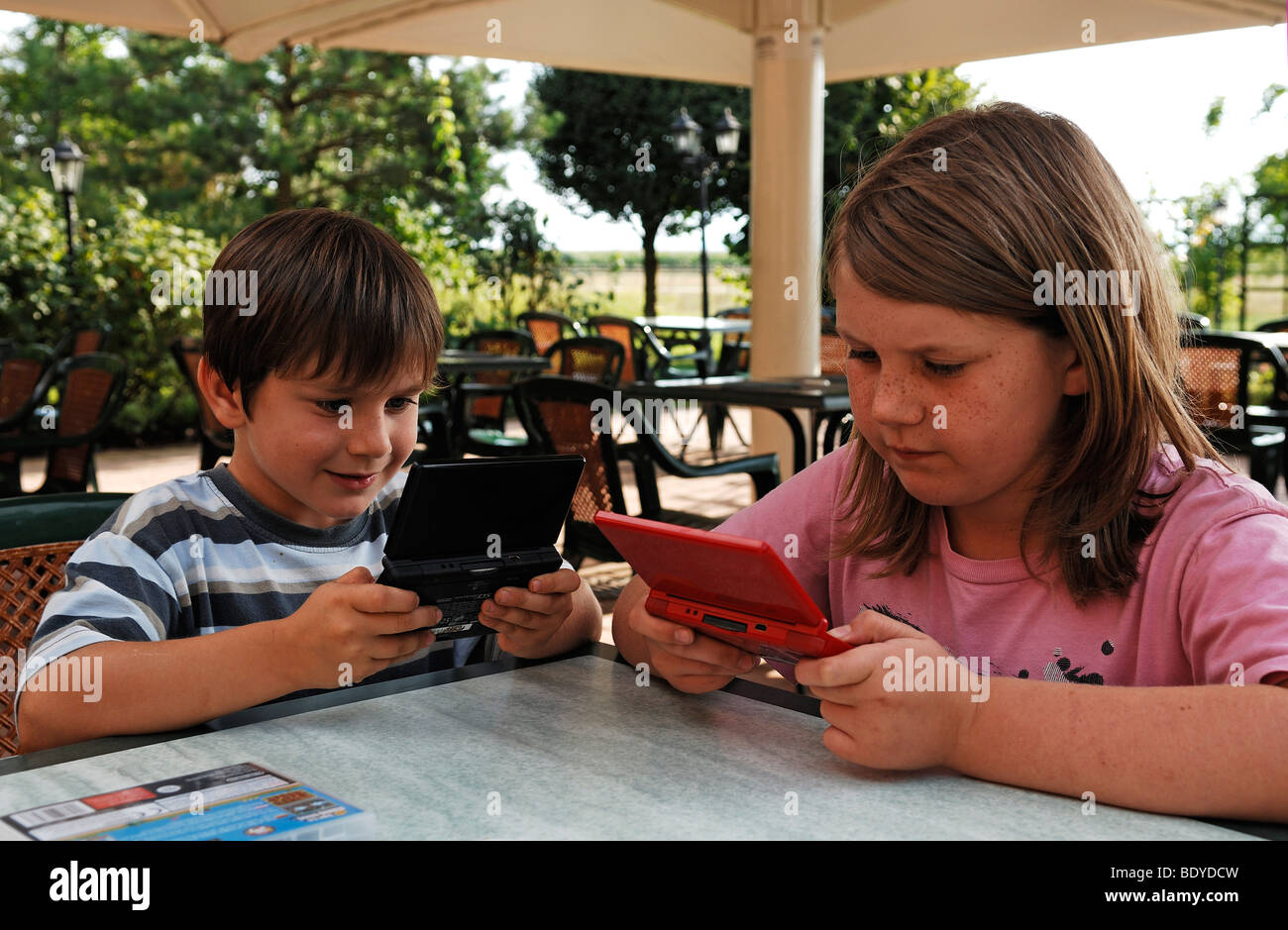 Boy and girl playing with their DS games, Dual Screen Games Stock Photo ...