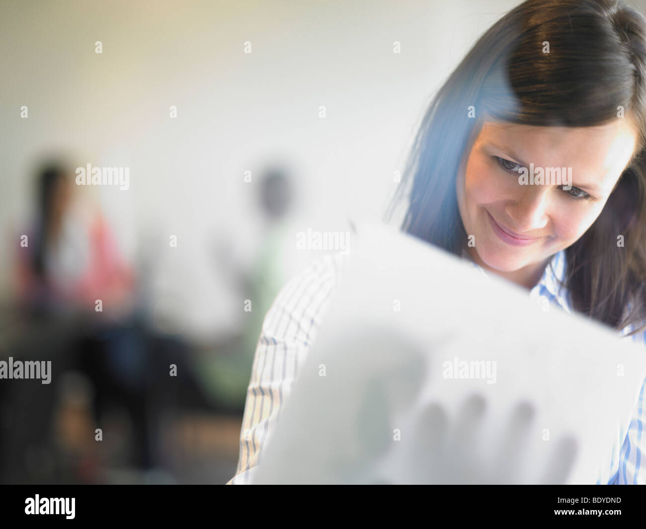 woman writing against window Stock Photo - Alamy