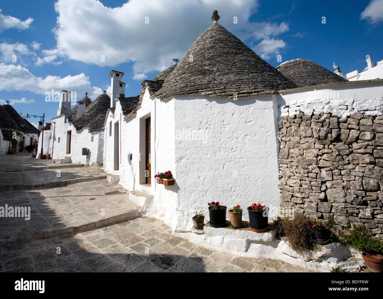 A Row of Trulli Houses in the town of Alberobello, Puglia, Italy Stock ...