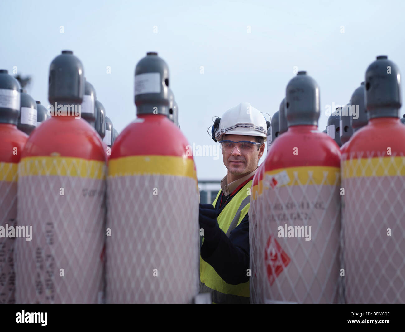 Port Worker Inspecting Gas Canisters Stock Photo - Alamy