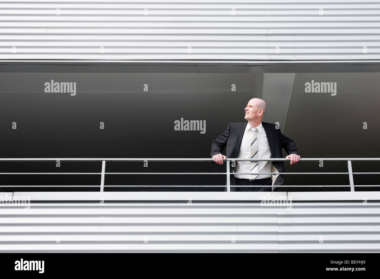 man leaning out observing Stock Photo - Alamy