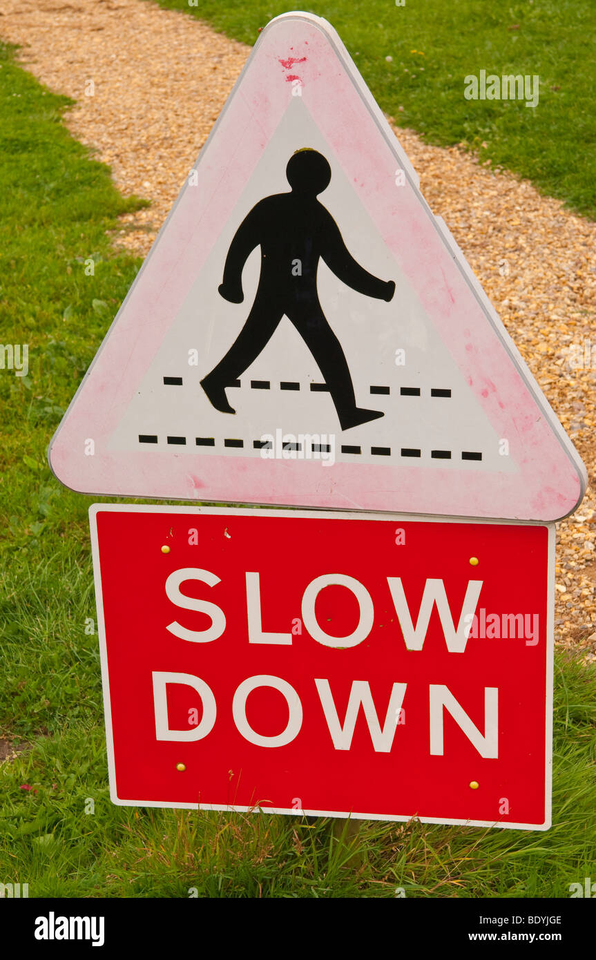 A road sign warning drivers to slow down for pedestrians crossing in ...