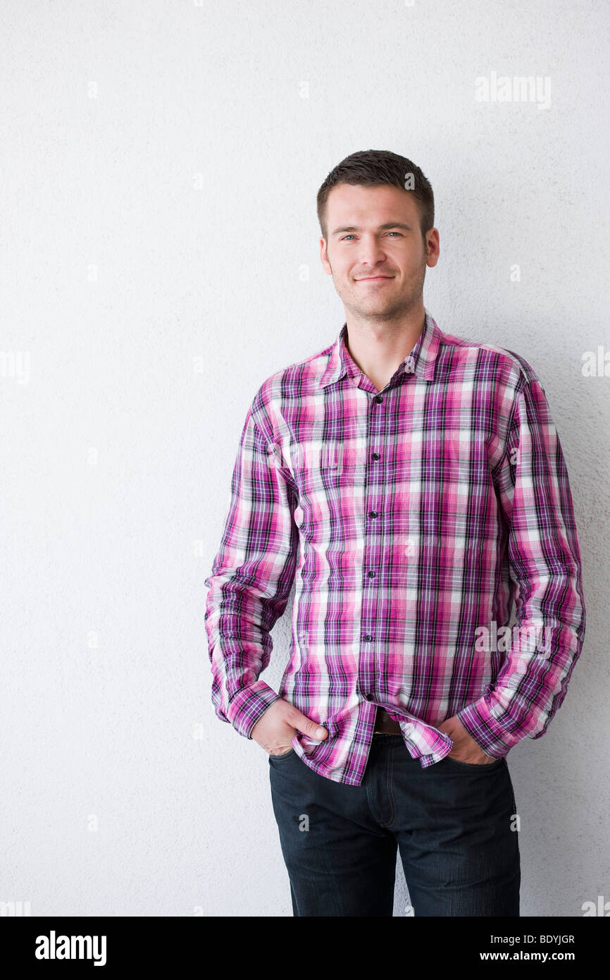 man standing in front of white wall Stock Photo - Alamy