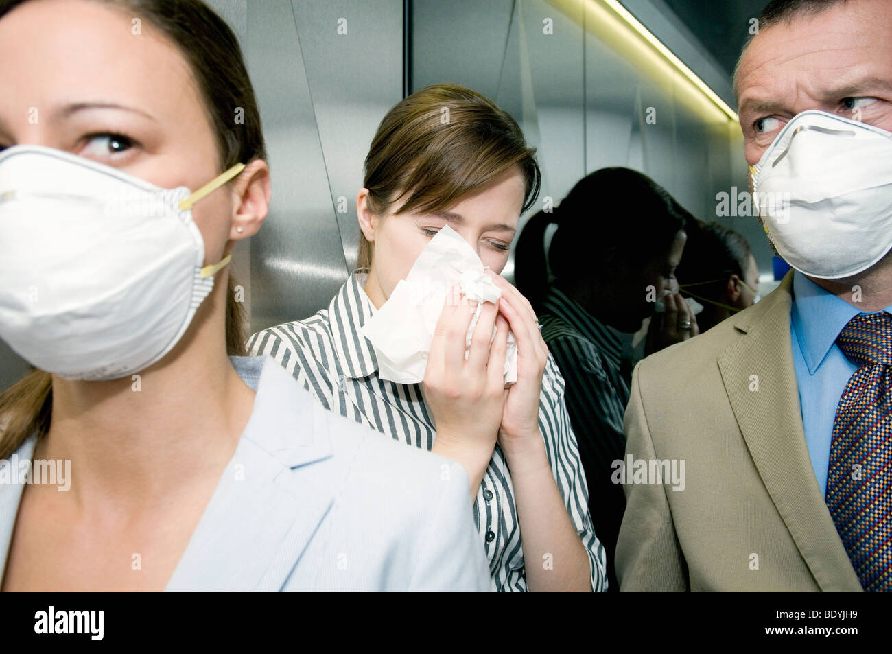 People in a lift during a health alert Stock Photo - Alamy