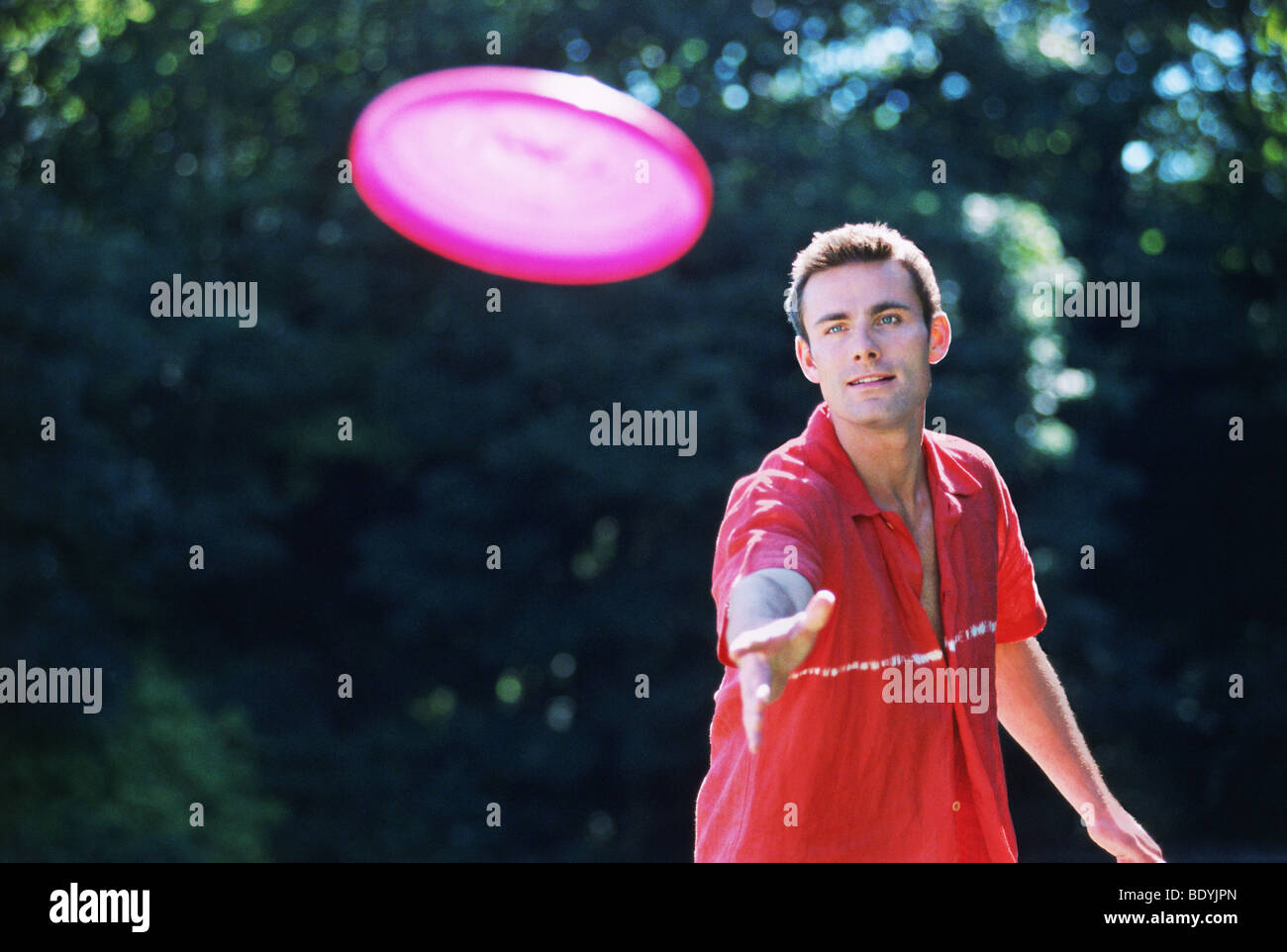A young man playing Frisbee Stock Photo - Alamy