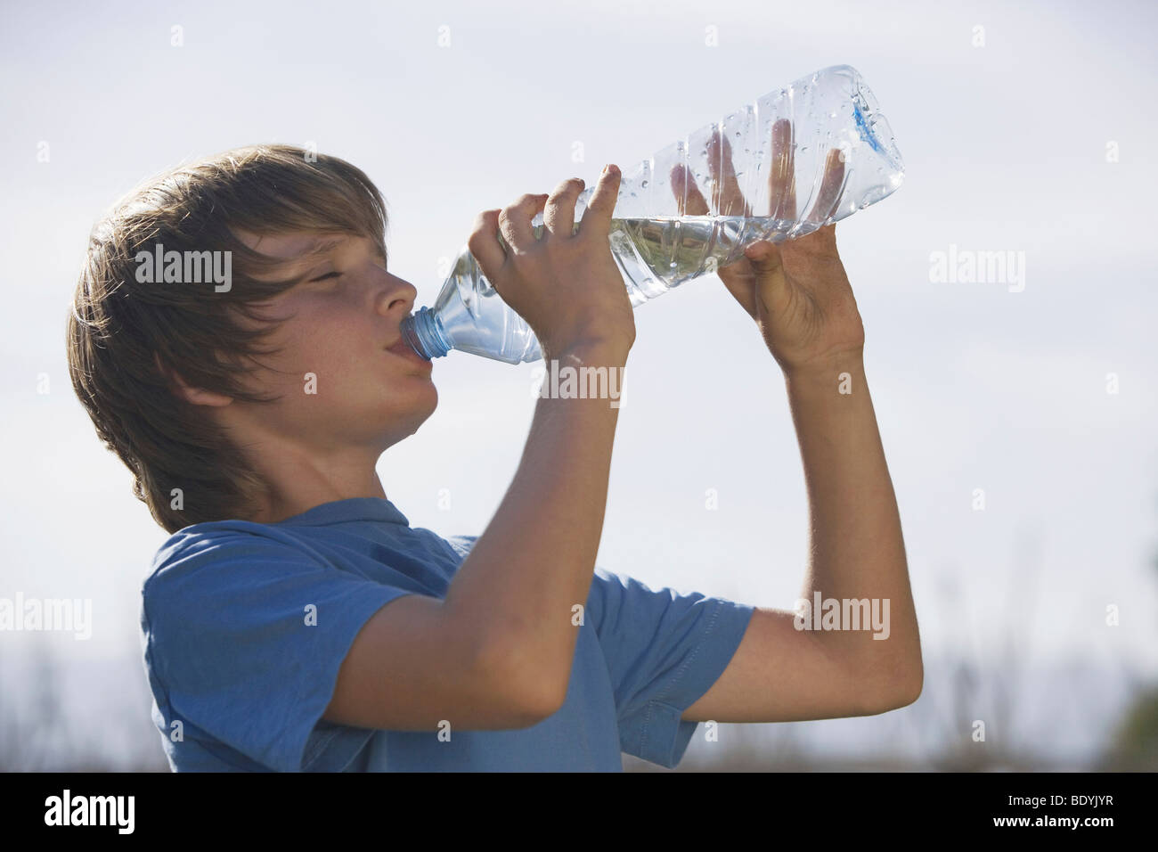 Low angle of boy drinking water Stock Photo - Alamy