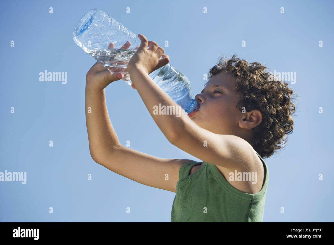 Low angle of young boy drinking water Stock Photo - Alamy