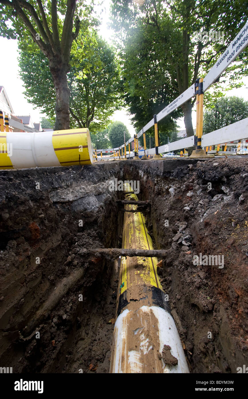 Thames Water pipe upgrade deep trench dug in road , North London Stock ...
