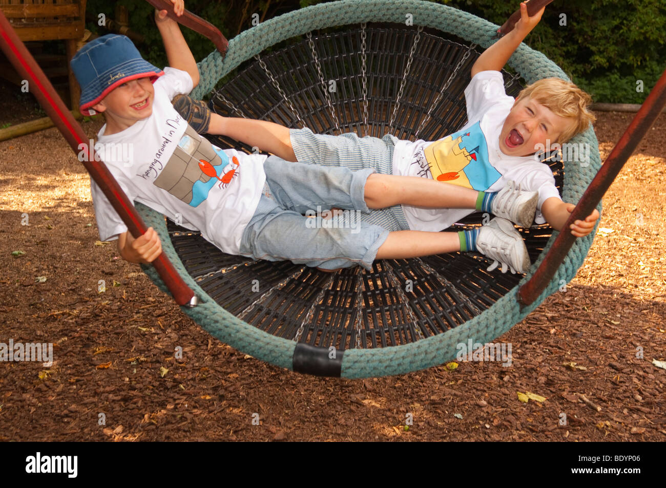 Two boys playing on swings hi-res stock photography and images - Alamy