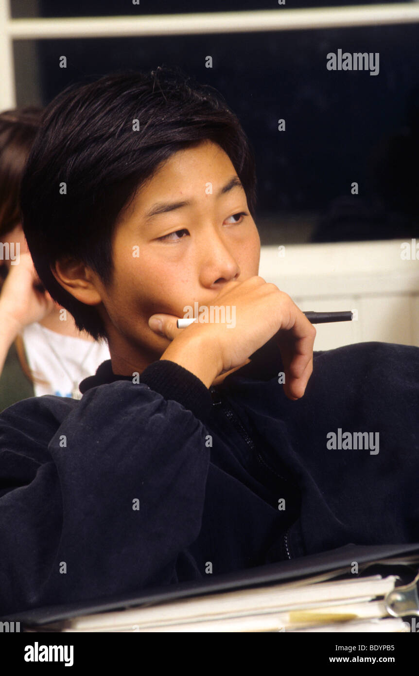 Boy listens intently during school lecture Stock Photo - Alamy