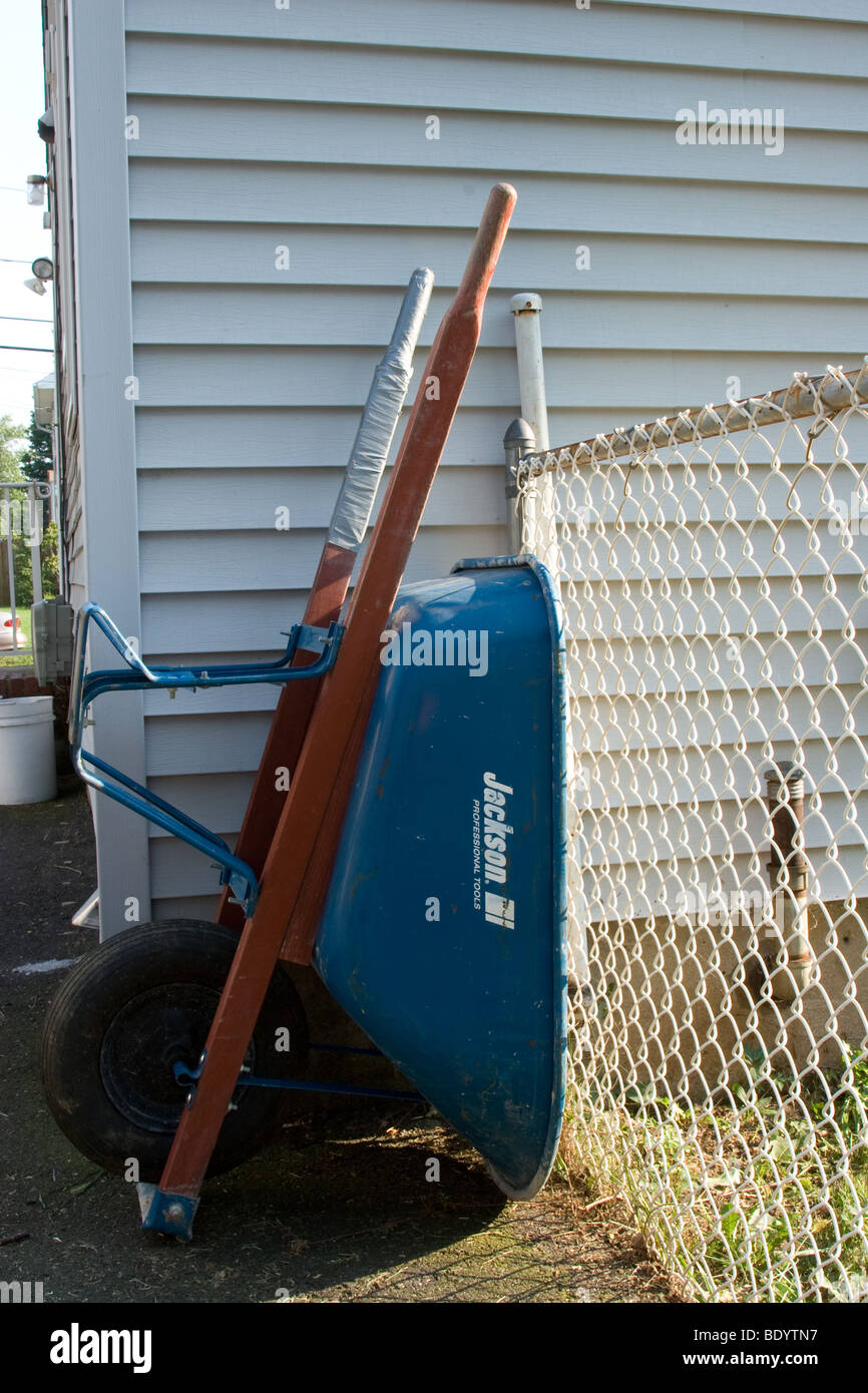 Wheel barrow and fence Stock Photo - Alamy