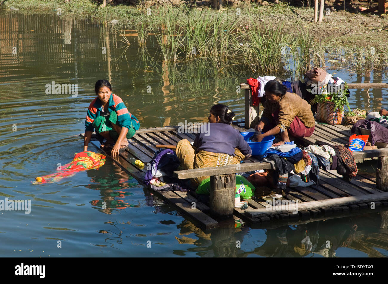 Women washing clothes on Inle Lake, Nyaungshwe, Shan State, Burma ...