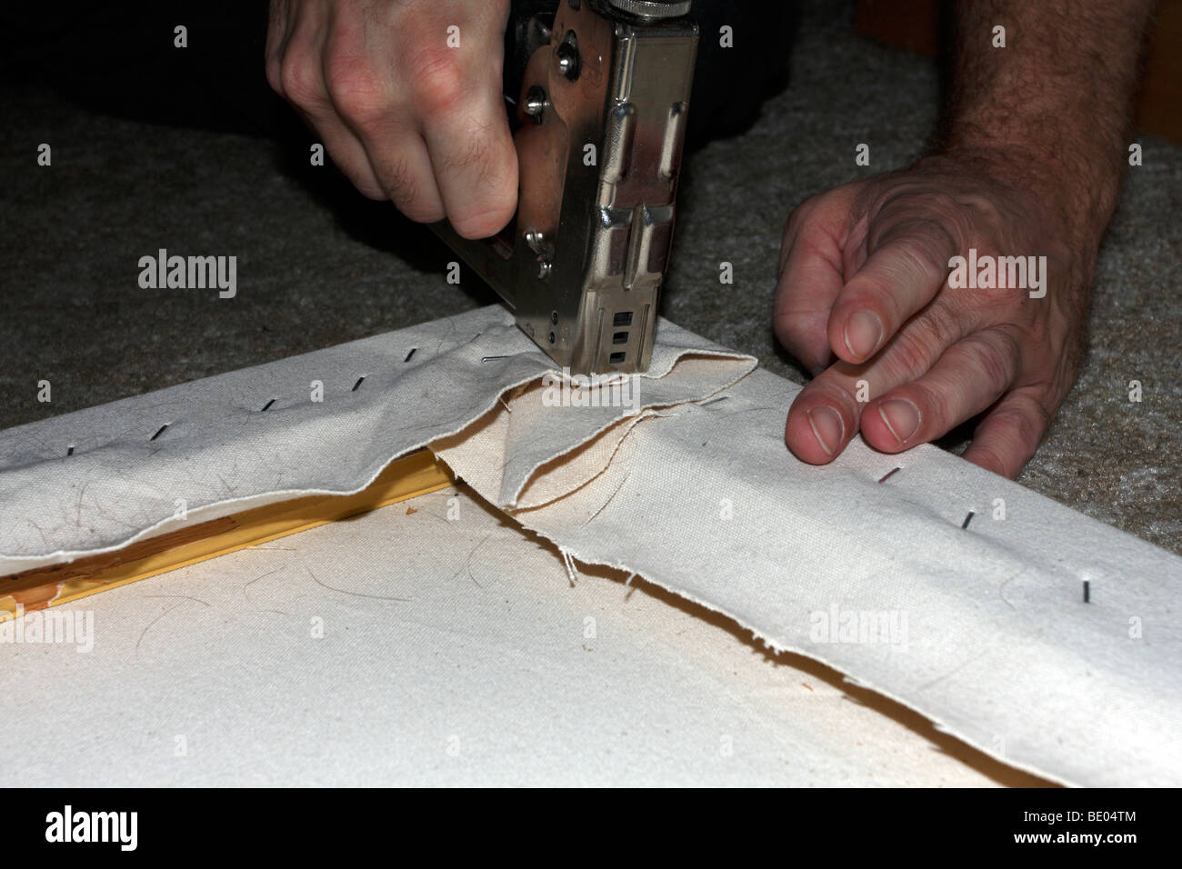 Stretching art canvas, stapling edge Stock Photo - Alamy