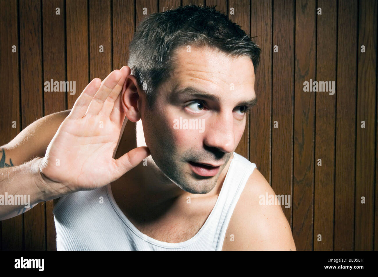 Man cupping ear hi-res stock photography and images - Alamy