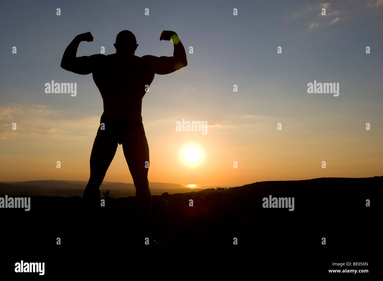 Bodybuilder Poses at Sunset Stock Photo - Alamy