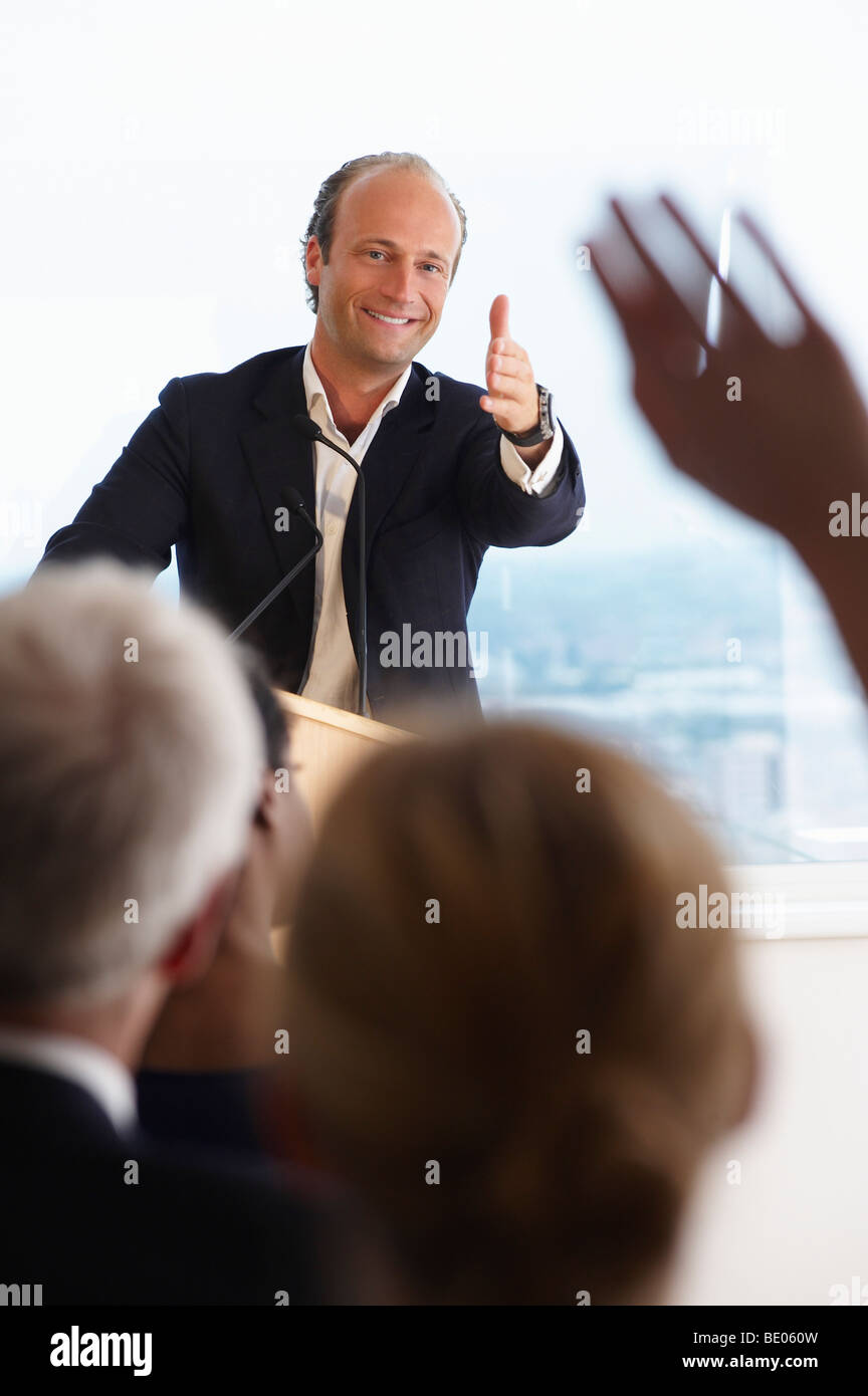 Standing pointing smiling communication microphone authority hi-res ...