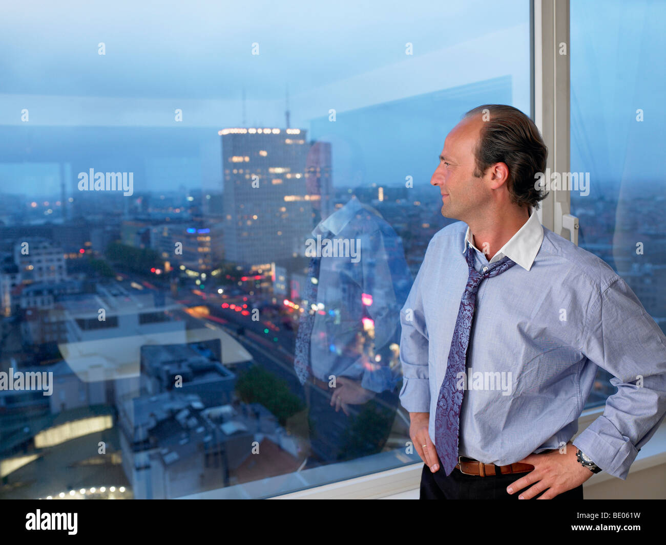 Business man looking through the window Stock Photo - Alamy