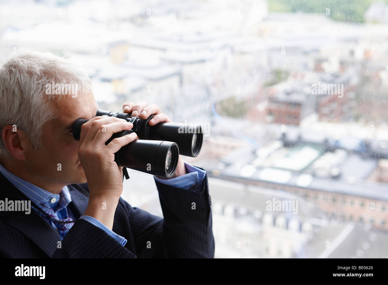 Man with binoculars Stock Photo - Alamy
