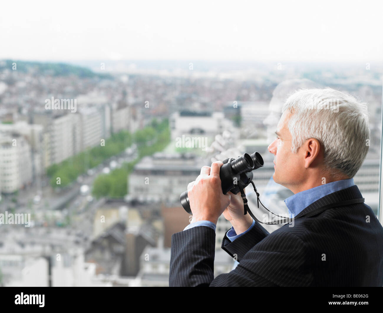 Man with binoculars Stock Photo - Alamy