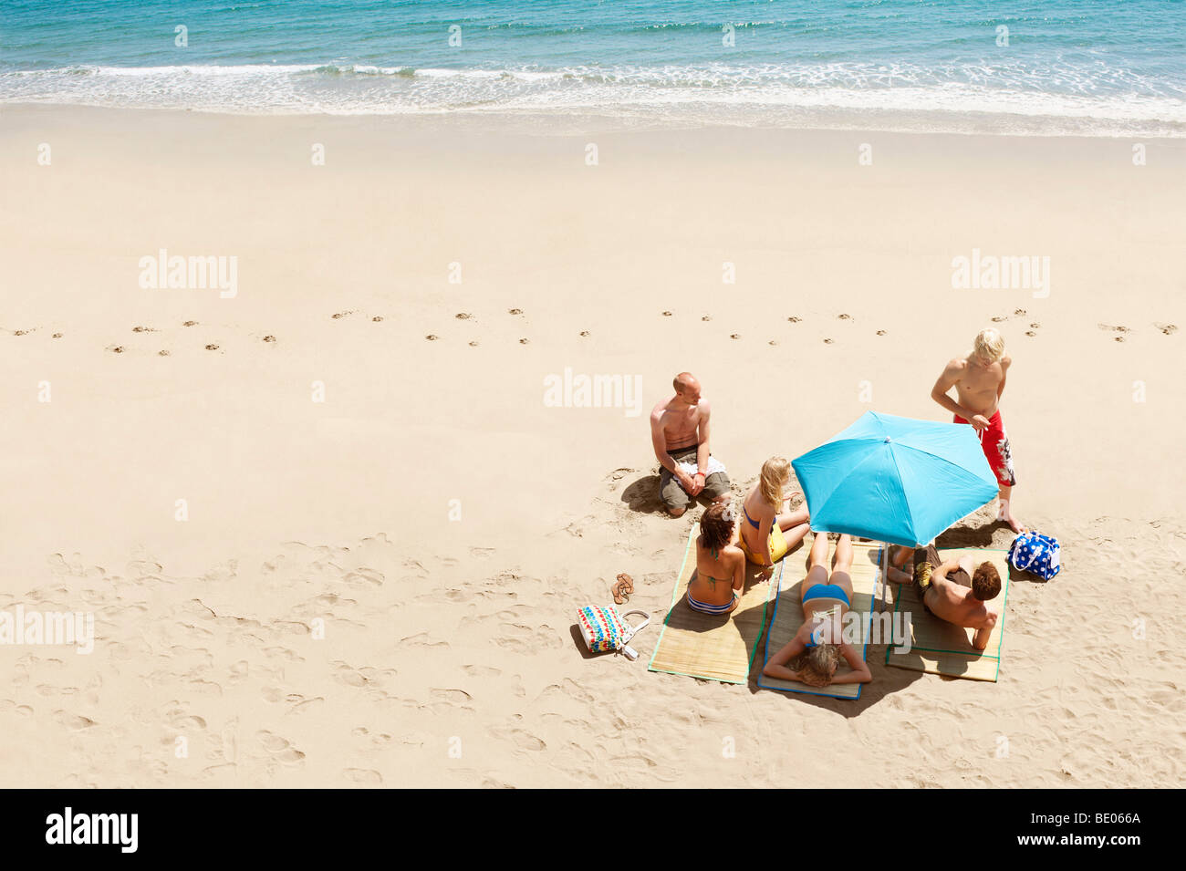 group of people sunbathing on beach Stock Photo - Alamy