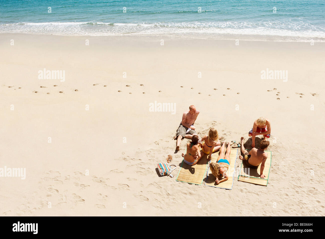 group of people sunbathing on beach Stock Photo - Alamy