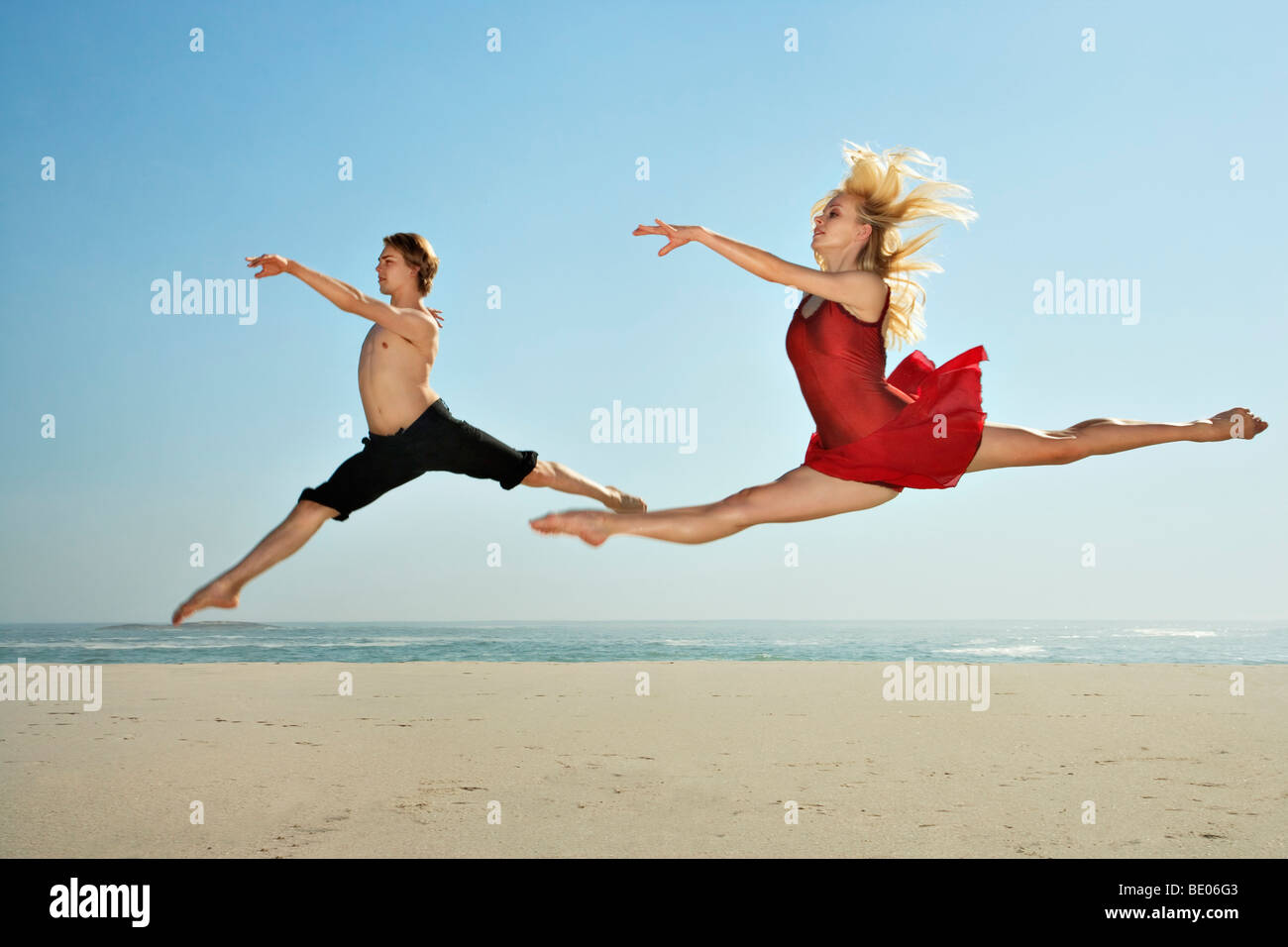 Dancers leaping on a beach Stock Photo - Alamy