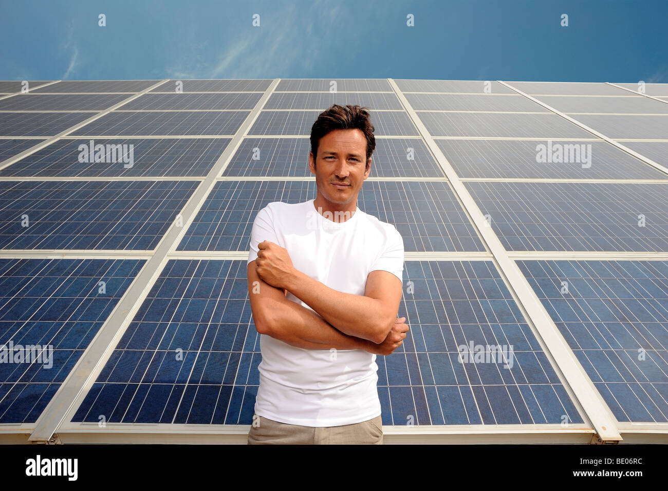 Man standing in front of solar panel Stock Photo - Alamy