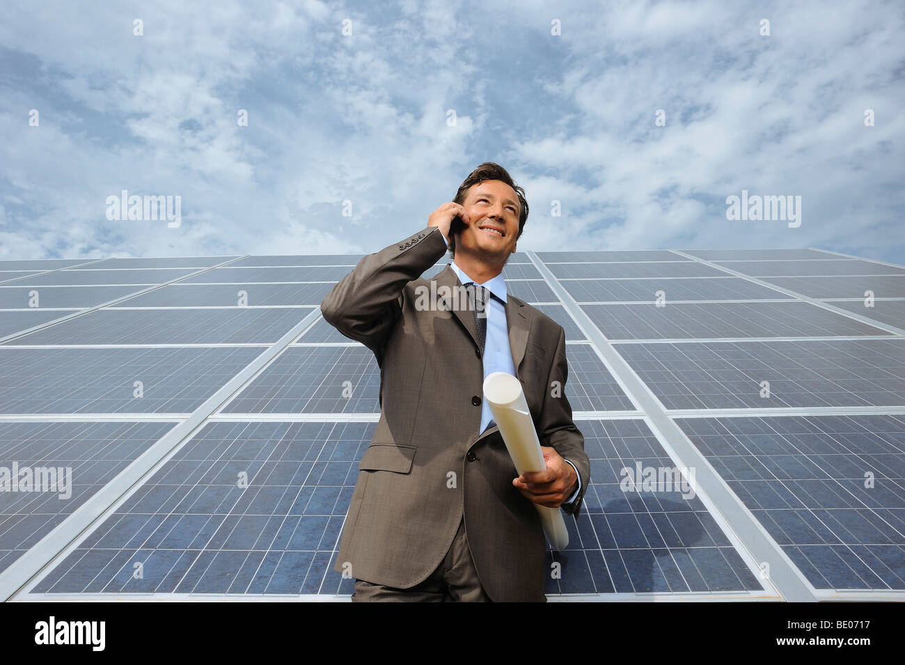 Man standing in front of solar panel Stock Photo - Alamy
