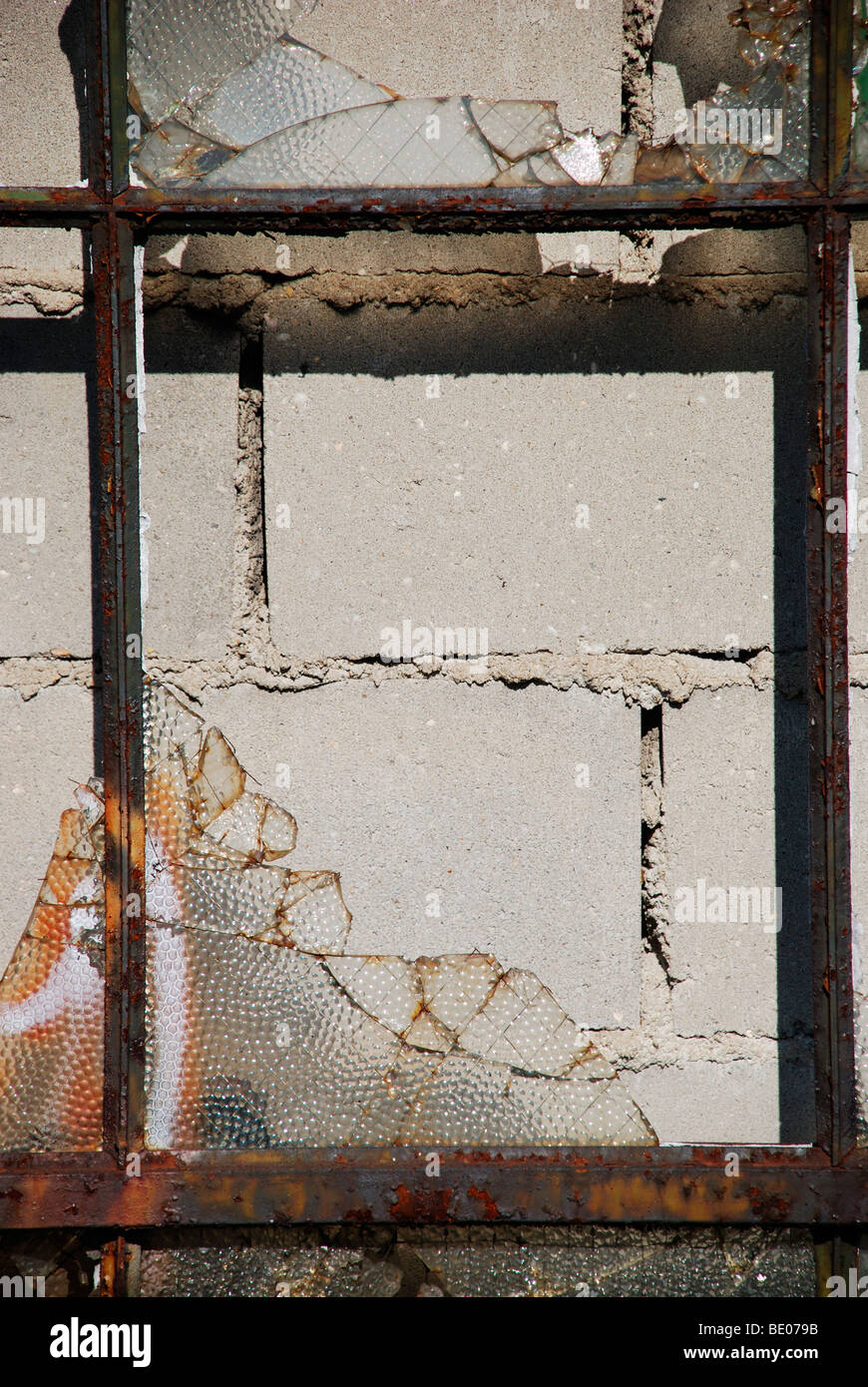exterior of broken window closed up from the inside with concrete ...