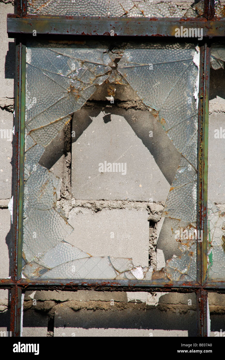 exterior of broken window closed up from the inside with concrete ...