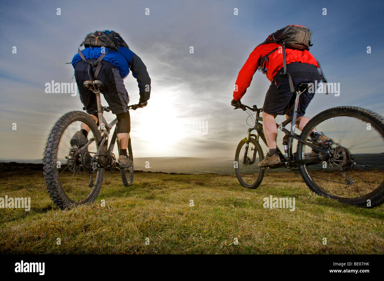 Two mountain bikers riding together Stock Photo - Alamy
