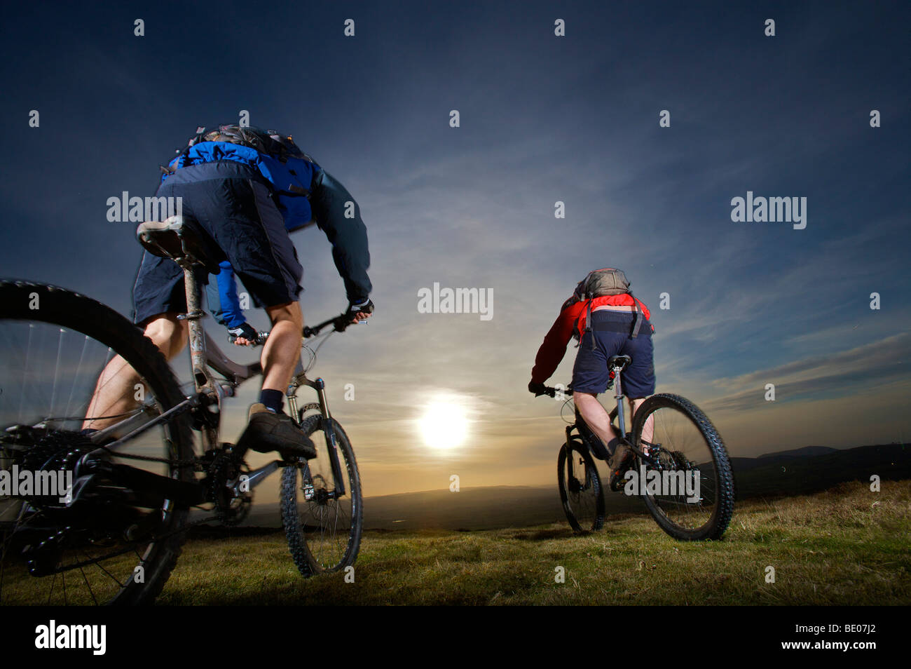Two mountain bikers riding together Stock Photo - Alamy