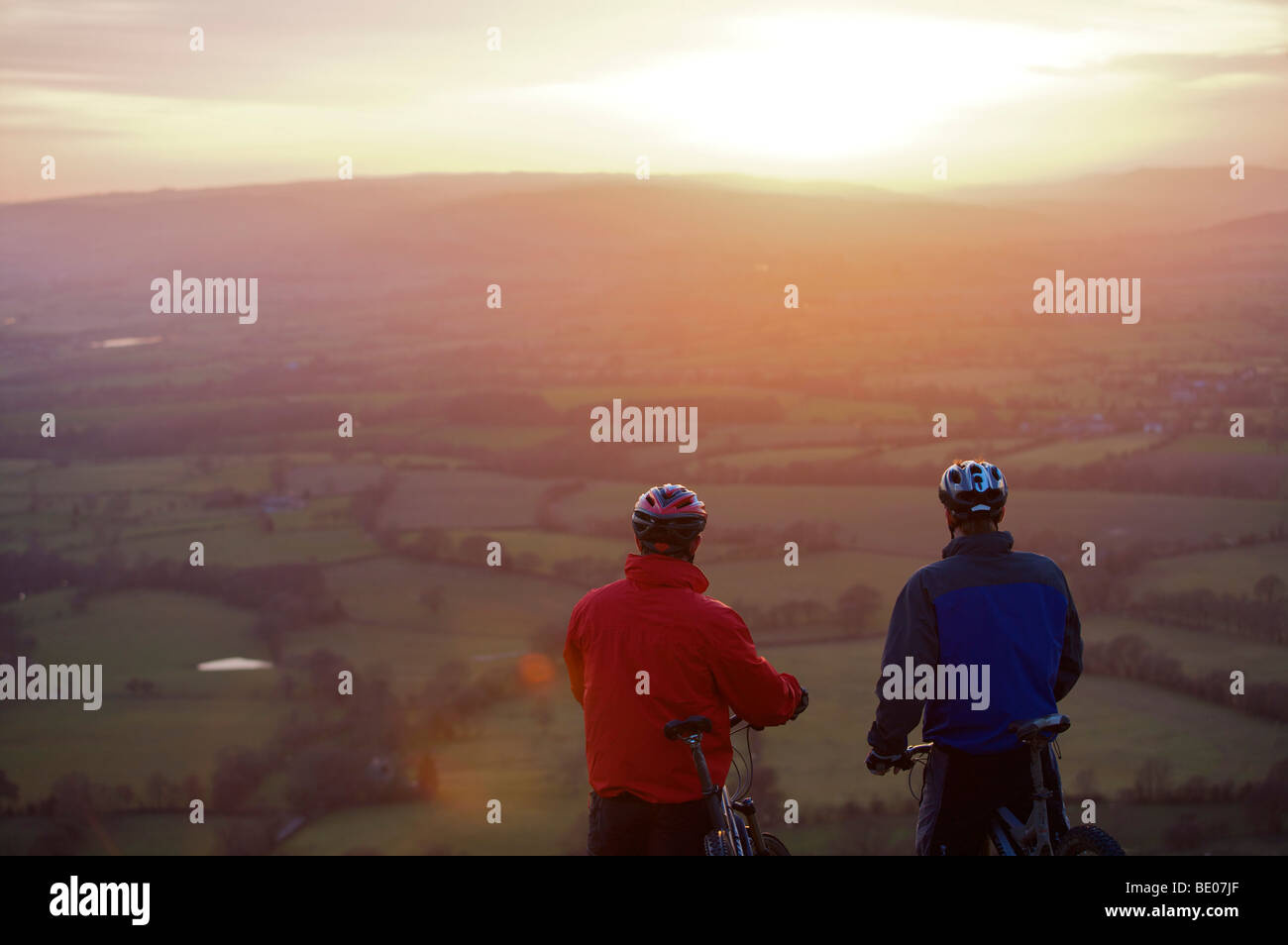 Two mountain bikers viewing scene Stock Photo - Alamy