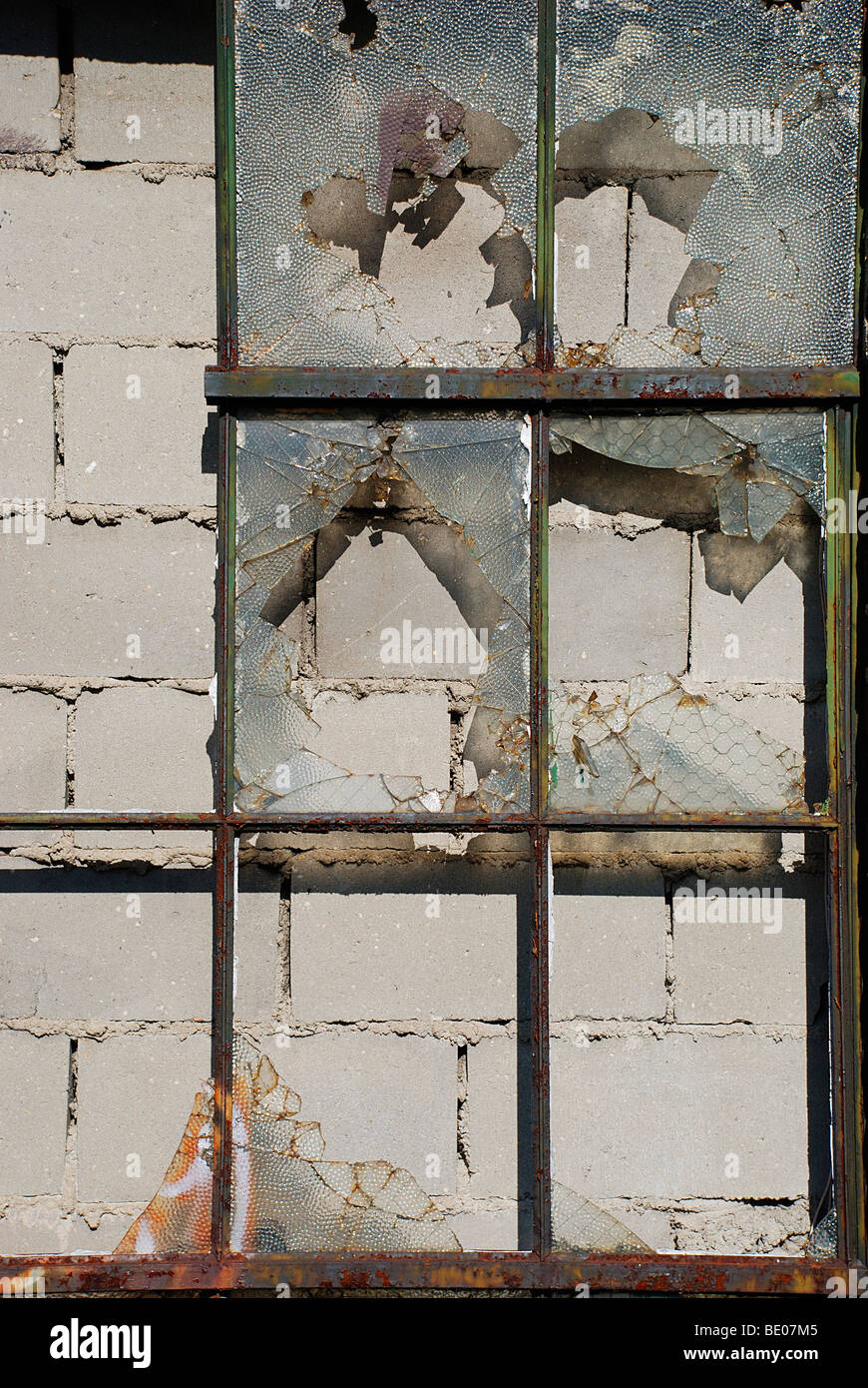 exterior of broken window closed up from the inside with concrete ...