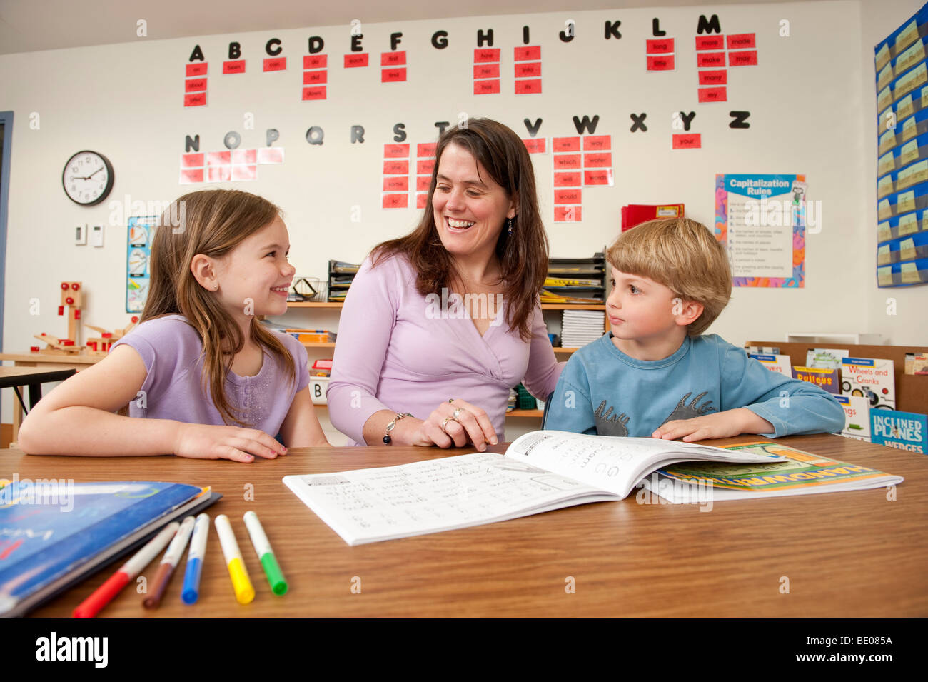 Teacher Helping Students Stock Photo - Alamy